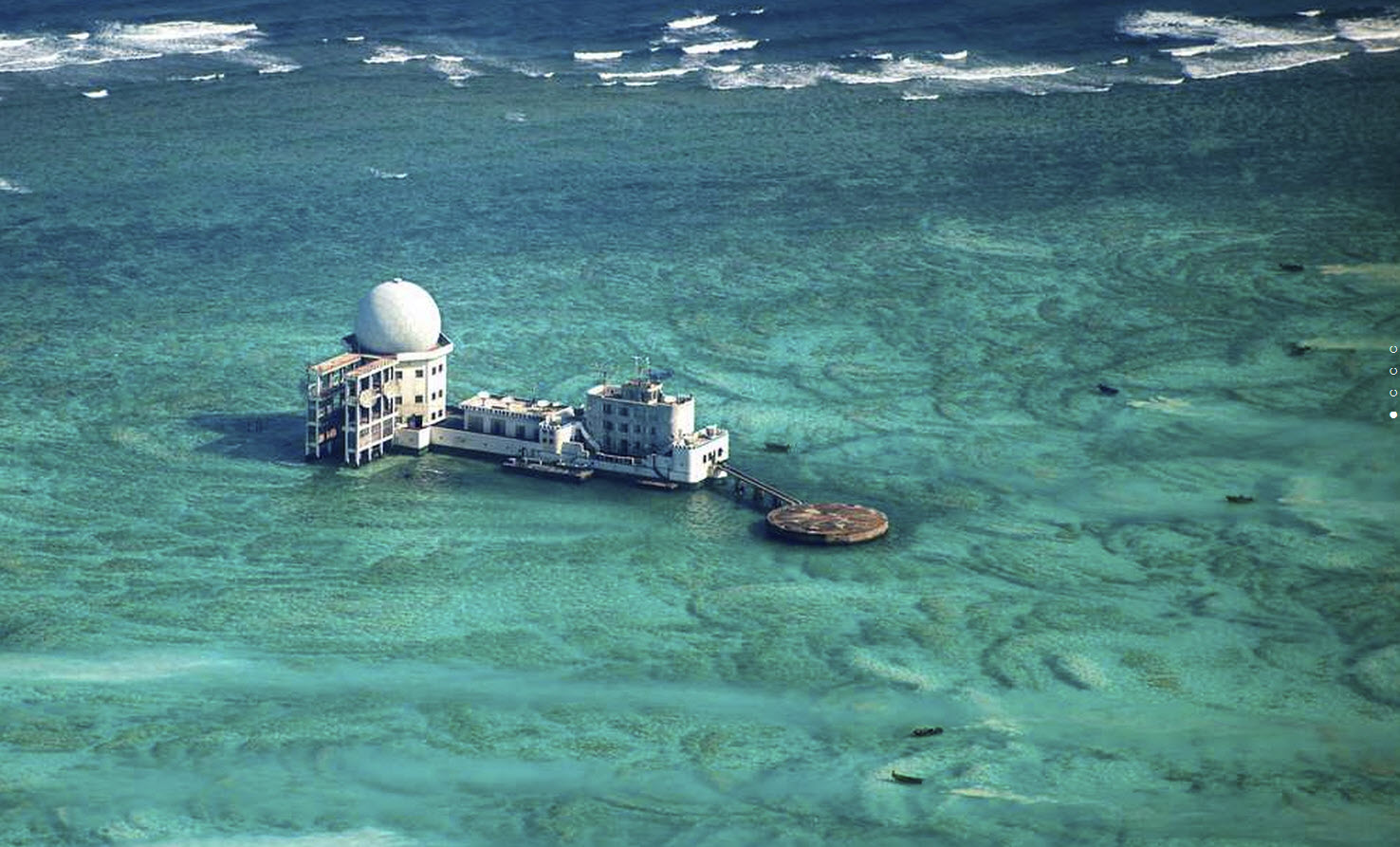 Military structure consisting of a 3-story building, wharf and helipad
